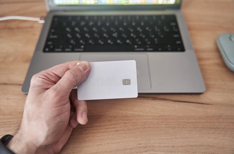 Person Holds Credit Card in Front of Computer for Online Transaction ...
