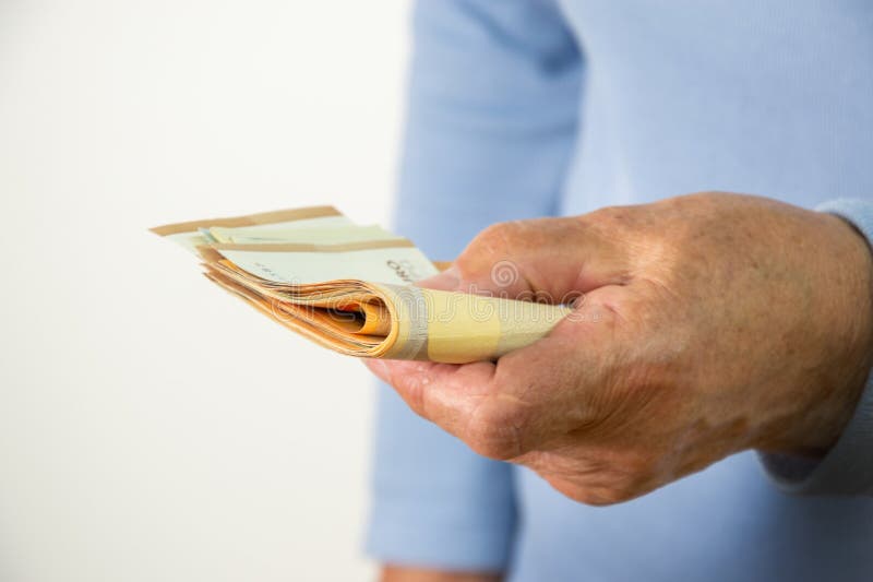 A Person Holds a Stack of Folded Cash in Their Hands Stock Image ...