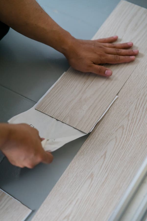 A Person Installing New Vinyl Tile Floor, a DIY Home Project Stock ...