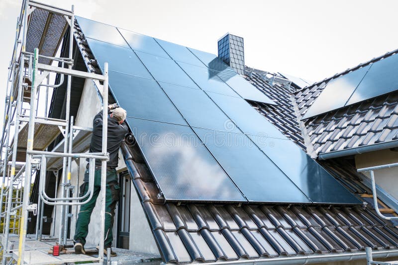 Person Installing Solar Panels at the Construction Site of a House ...