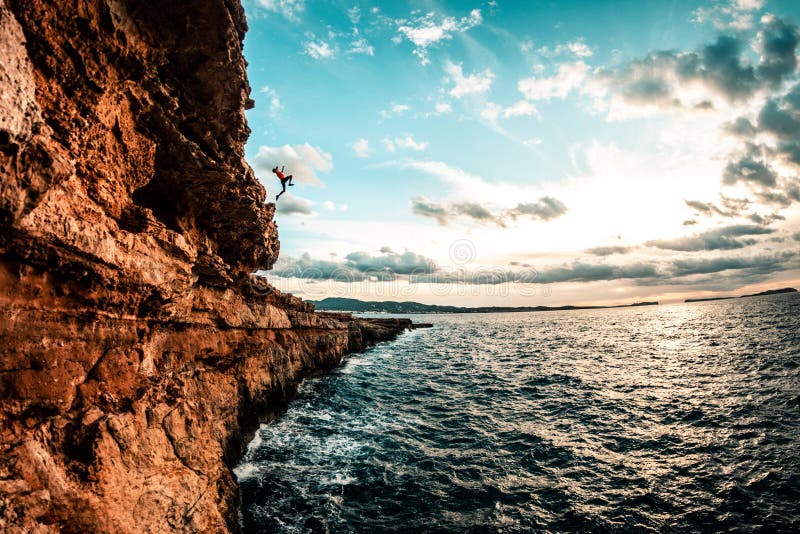 Person Jumping from a Coastal Clff Stock Photo - Image of ocean, rock ...