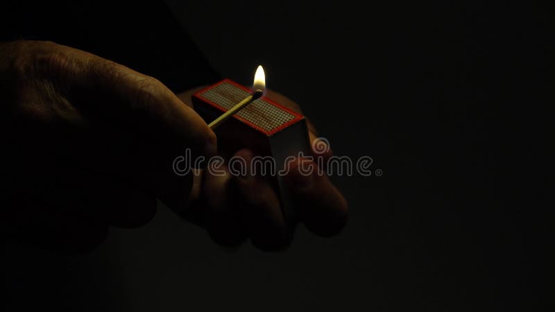 Person Lighting a Matchstick Emerging from the Darkness Stock Video ...