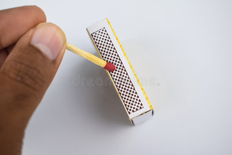 A Person Lighting a Single Match Sticks by Swiping the Match with the ...