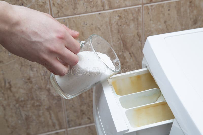 A Person Loads Washing Powder into a Washing Machine Stock Photo ...