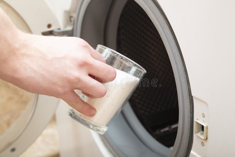 A Person Loads Washing Powder into a Washing Machine Stock Image ...