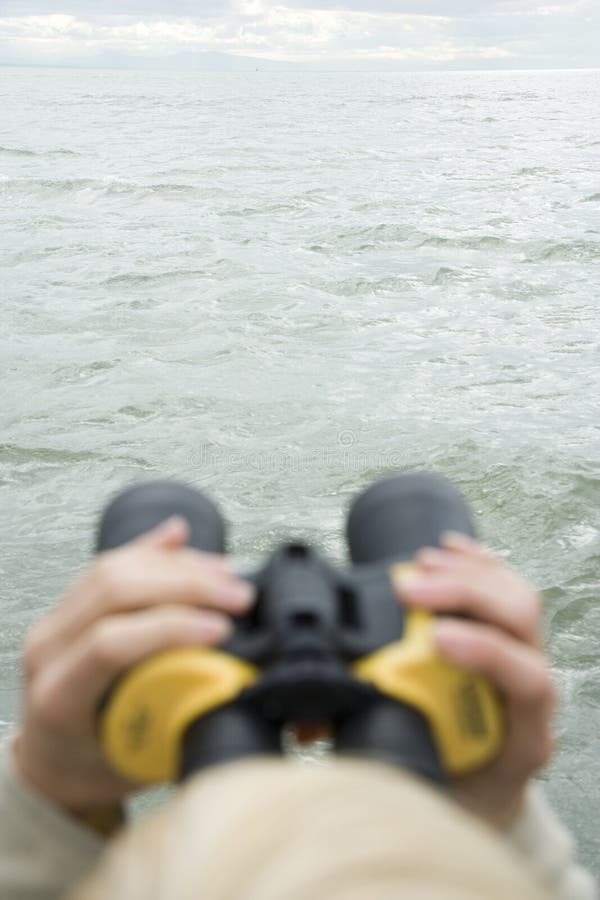 Person Looking Across Water through Binoculars Stock Image - Image of ...