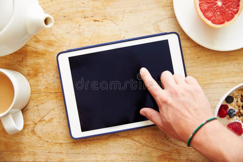 Person Looking at Digital Tablet Whilst Eating Breakfast Stock Image ...