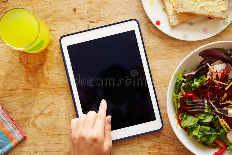 Person Looking at Digital Tablet Whilst Eating Lunch Stock Image ...