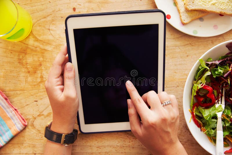 Person Looking at Digital Tablet Whilst Eating Lunch Stock Image ...