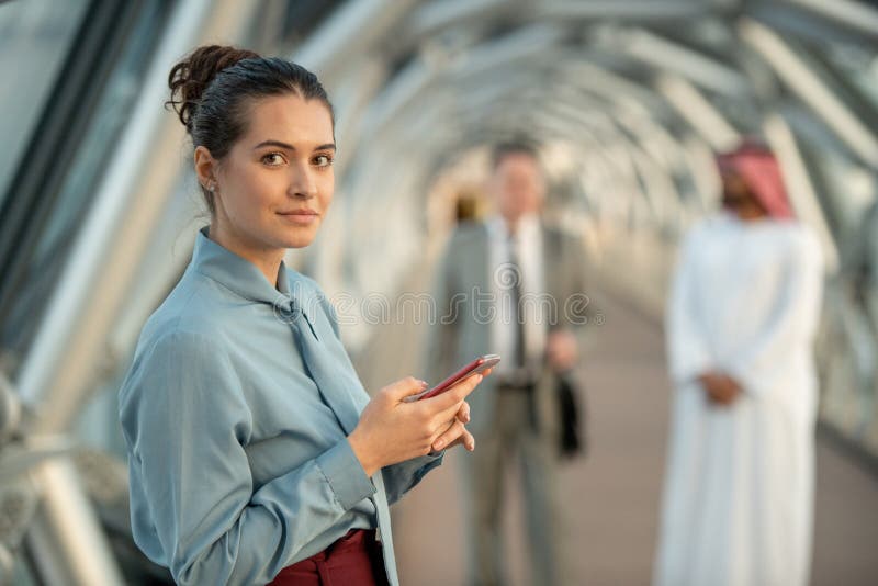 A Person Looking at Young while Using Mobile Phone Stock Photo - Image ...