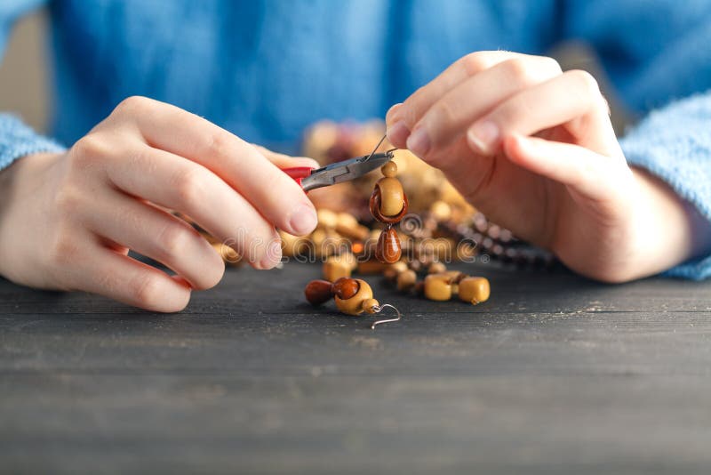 Person Making Jewelry Using Wire, Chains and Beads and Other Materials ...