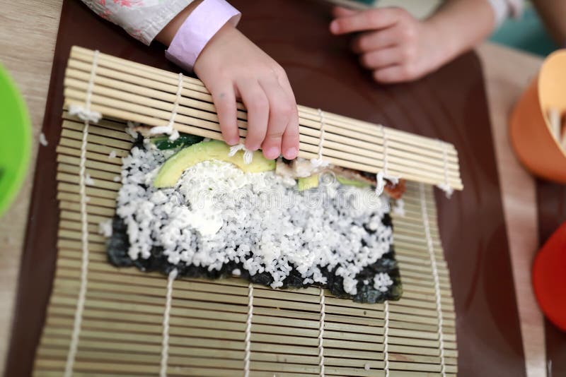Person making sushi stock photo. Image of making, crockery - 130013180