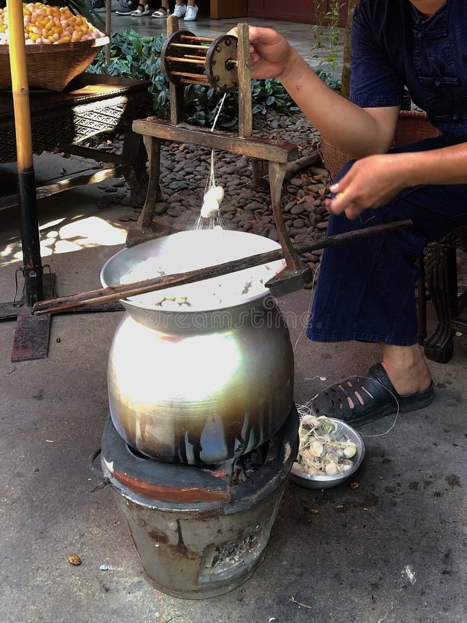 Traditional Silk Reeling Process with Spinning Wheel and Boiling Water ...