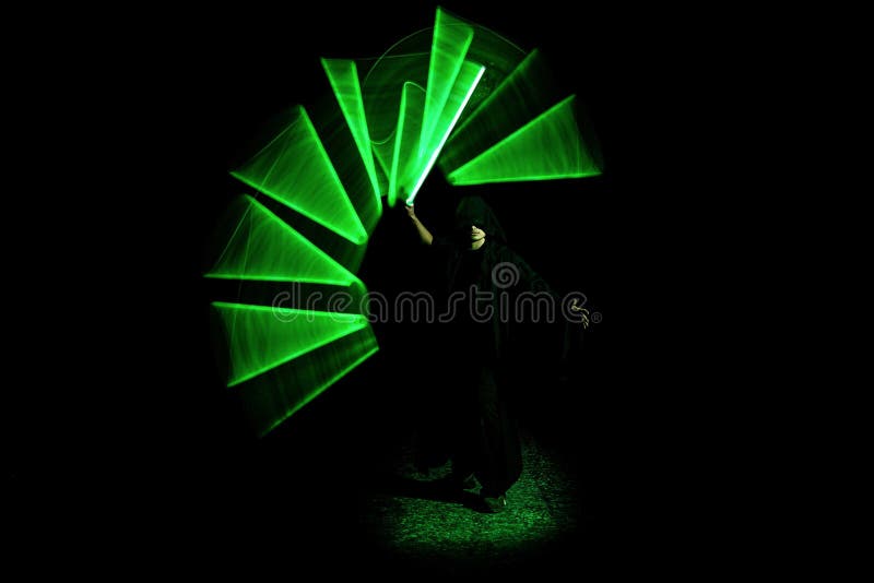 Person Moving a Green Led Light Stick in the Dark Stock Image - Image ...