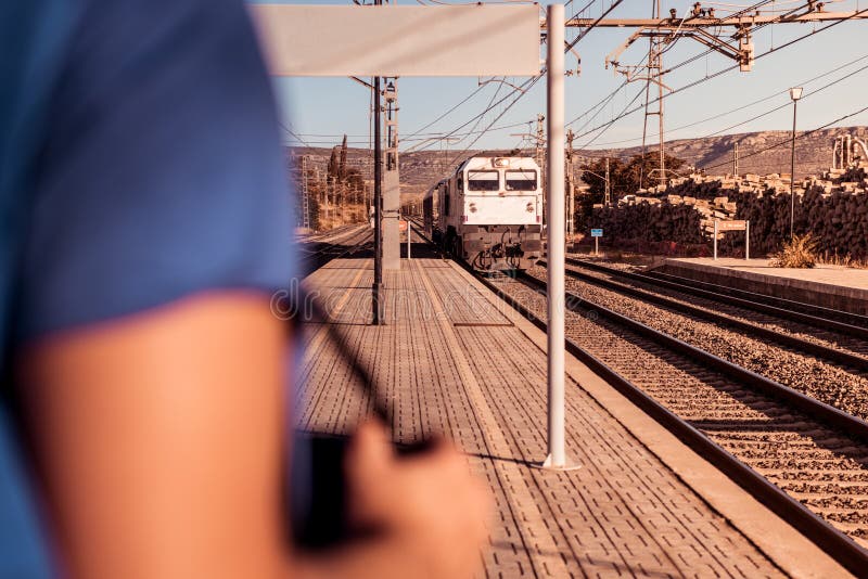 Person Near the Train Tracks while the Train is Approaching Stock Image ...