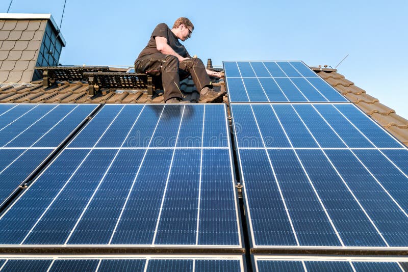 Person Next To Solar Panels on a Rooftop Stock Photo - Image of sunny ...