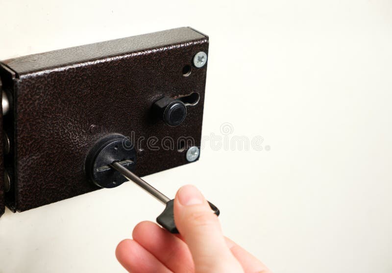 A Person Opens a Modern Durable Lock with a Key, a Close-up Hand. Stock ...