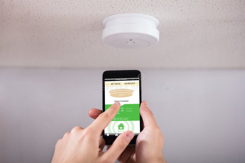 Person Operating Smoke Detector with Mobile Phone Stock Photo - Image ...