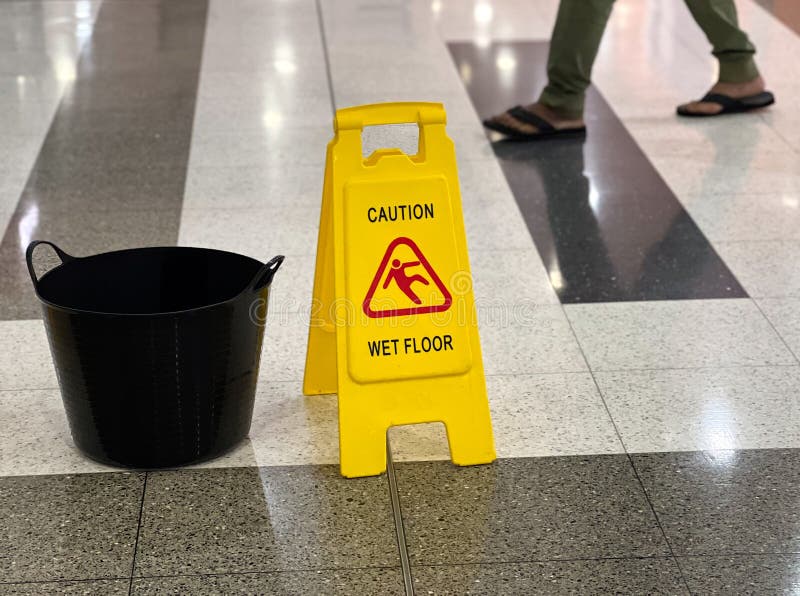 Person Passing by a Caution Wet Floor Sign Stock Image - Image of ...