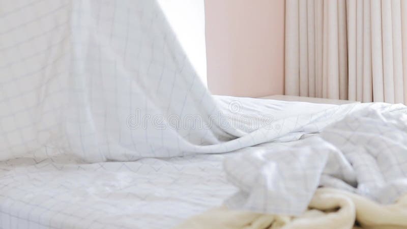 A Person Performs a Household Task of Making the Bed by Adjusting the ...
