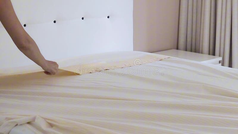 A Person Performs a Household Task of Making the Bed by Adjusting the ...