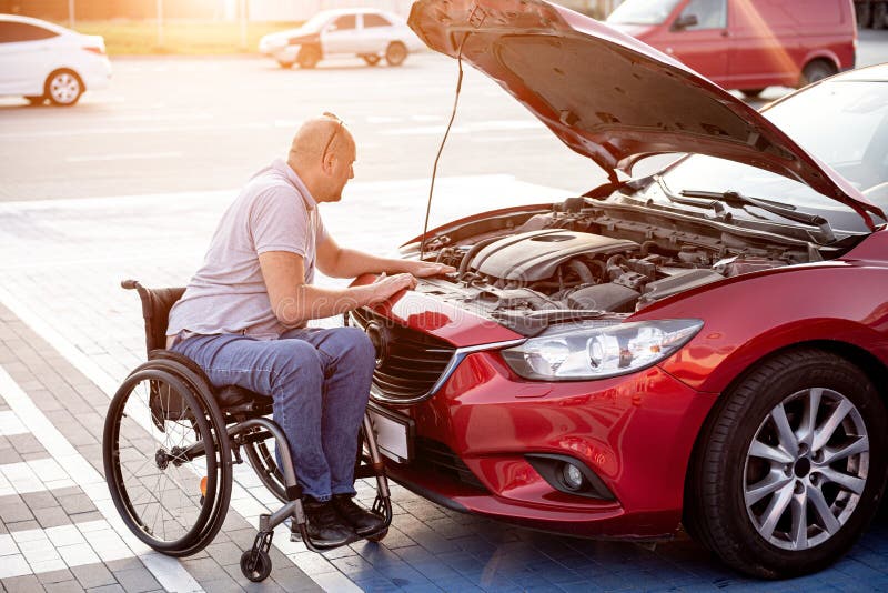 Person with a Physical Disability Check Engine His Car at Parking Stock ...