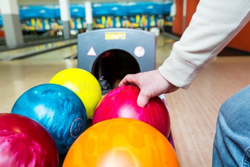Person Picking Bowling Ball from Rack Stock Image - Image of ...