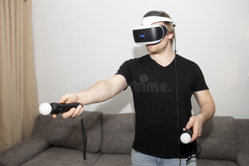 A Person Plays in Virtual Reality. a Young Man Plays a Computer Game in ...