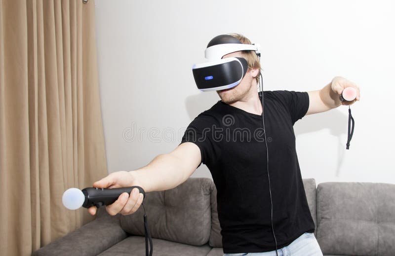 A Person Plays in Virtual Reality. a Young Man Plays a Computer Game in ...