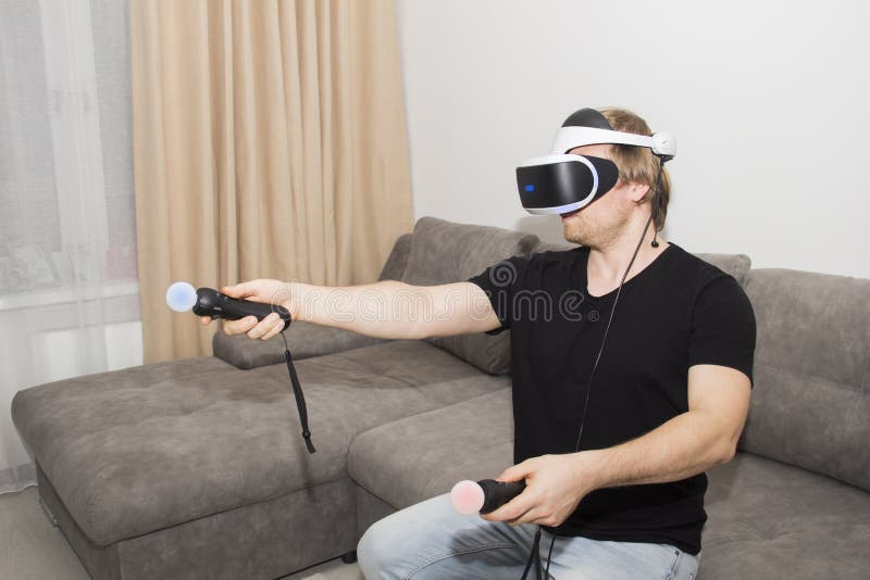A Person Plays in Virtual Reality. a Young Man Plays a Computer Game in ...