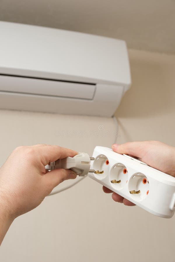 The Person Plugs the Air Conditioner Plug into the Outlet Stock Image ...