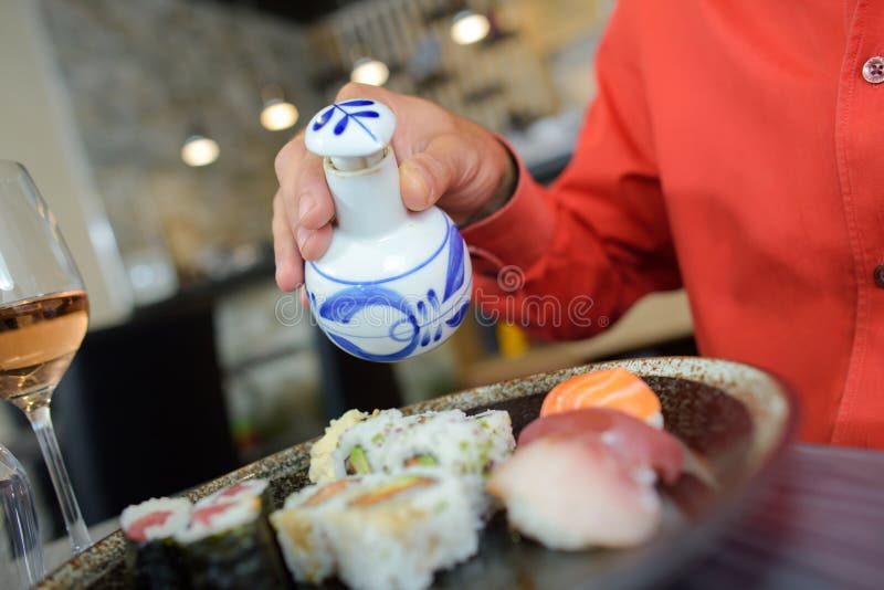 Person Pouring Condiment on Sushi Stock Photo - Image of hand, healthy ...