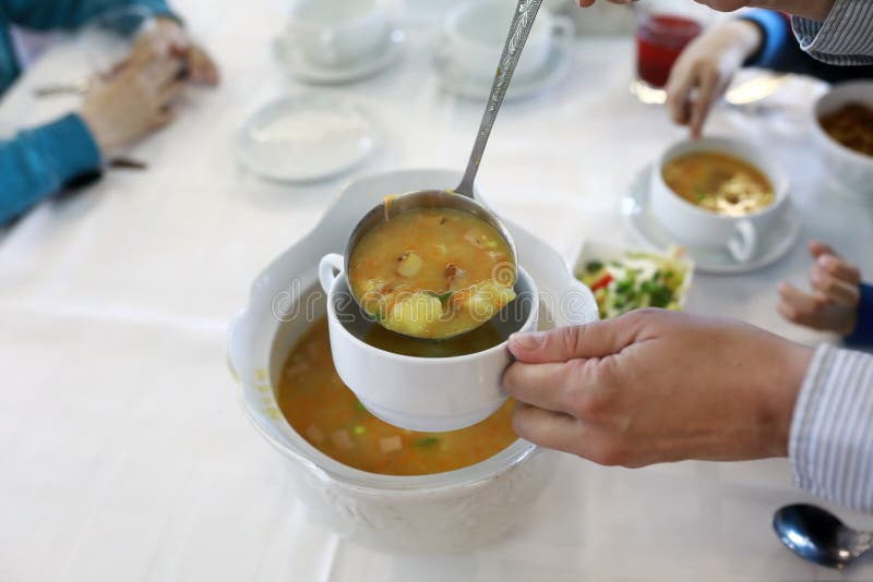 Pouring Soup in a Plate on Served Table with a Ladle Stock Photo ...