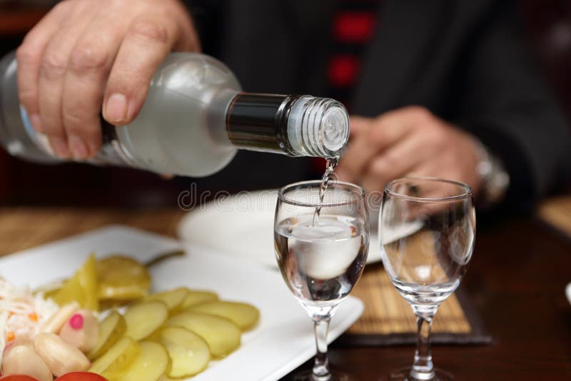 Person pouring vodka stock photo. Image of glass, liquid - 79896792