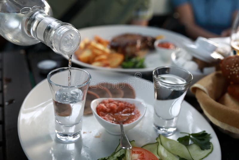 Person Pouring Vodka into Glasses Stock Image - Image of barkeeper ...