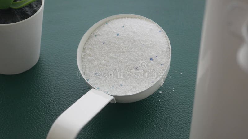 Measuring Laundry Detergent in a Bright Kitchen Area Stock Footage ...
