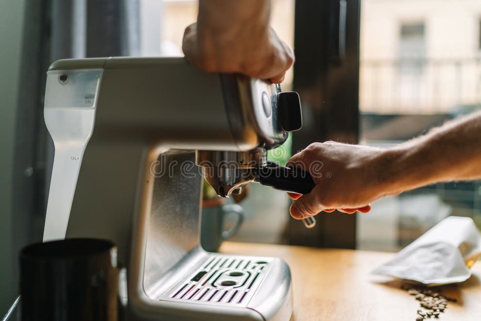 A Person Preparing Coffee Using an Espresso Machine in a Cozy Kitchen ...