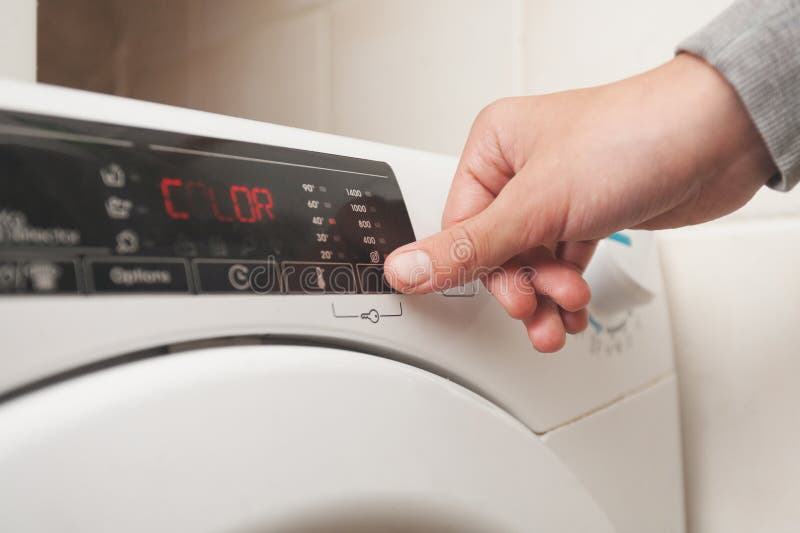 A Person Presses a Button To Select the Spin Cycle of the Washing ...