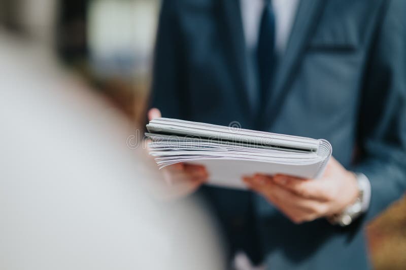 Business Professional Examining Documents and Papers during a Meeting ...