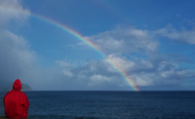 A Person with a Raincoat Looking at the Rainbow Stock Photo - Image of ...
