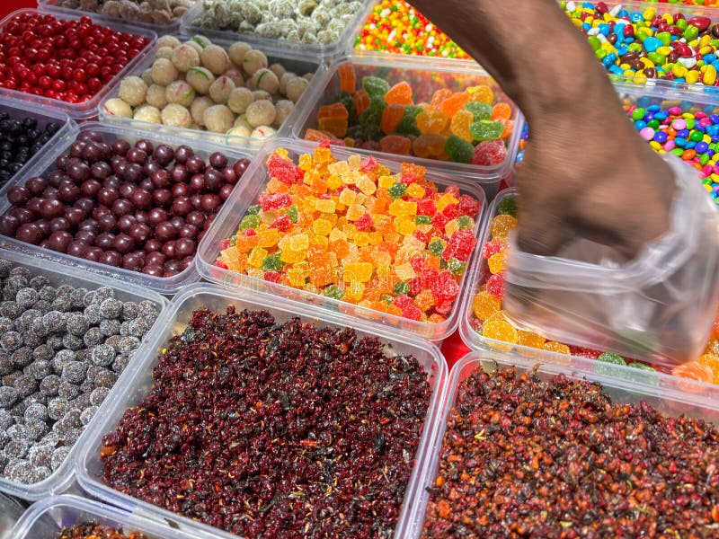 A Person is Reaching into a Container of Candy Stock Image - Image of ...
