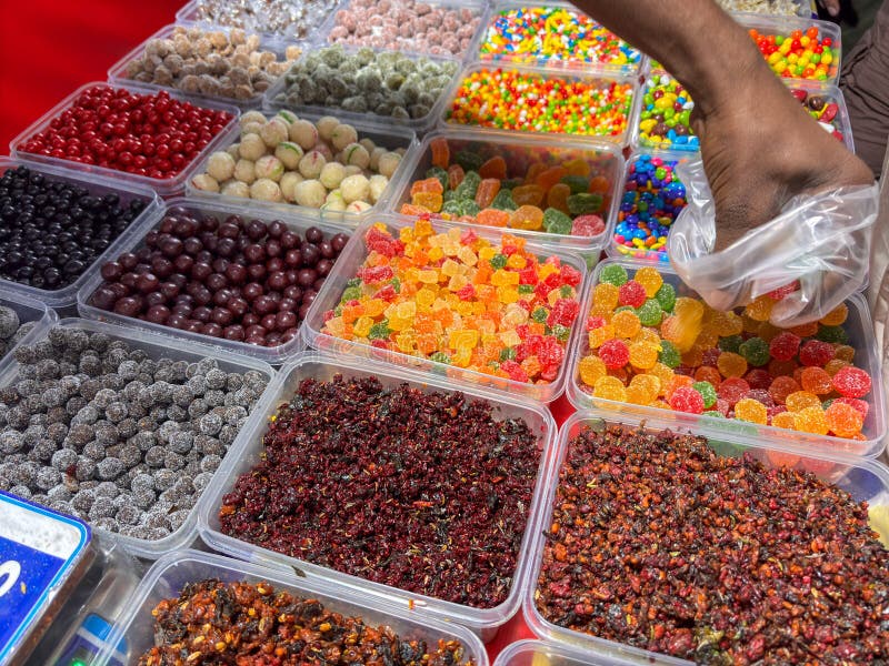 A Person is Reaching into a Pile of Candy Stock Photo - Image of ...
