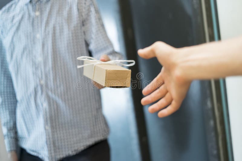 Mail Man Or Postman Delivering Or Giving Parcel Through Torn White ...