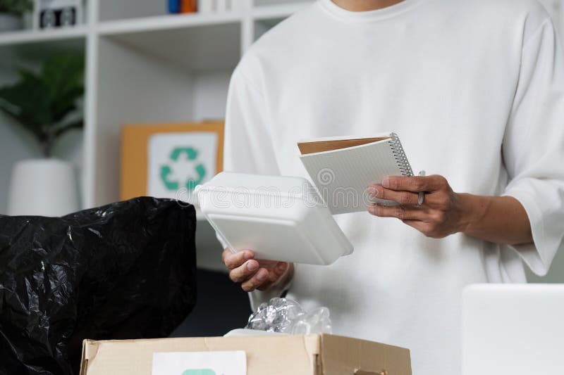 Person Recycling Packaging Materials and Organizing Notes in a ...