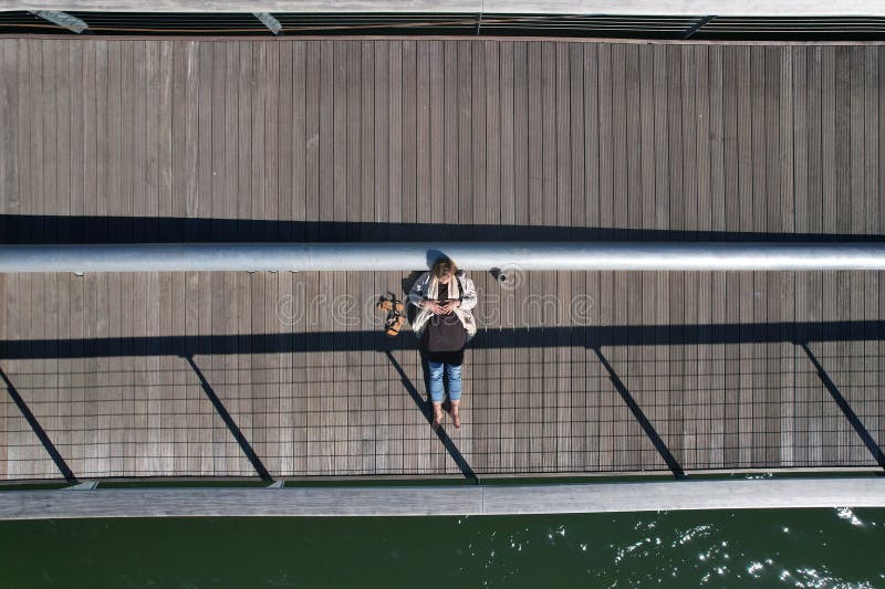 Person Relaxing on a Deck by the Water. Stock Image - Image of solitude ...