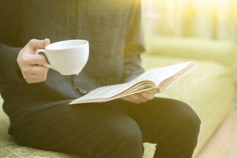 A Person Relaxing at Home, Reading Book and Drink Tea, Having Rest in ...