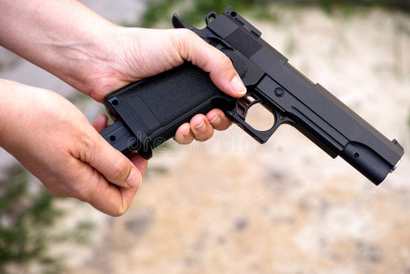 Person Reloading an Airsoft Gun Stock Photo - Image of trigger, round ...