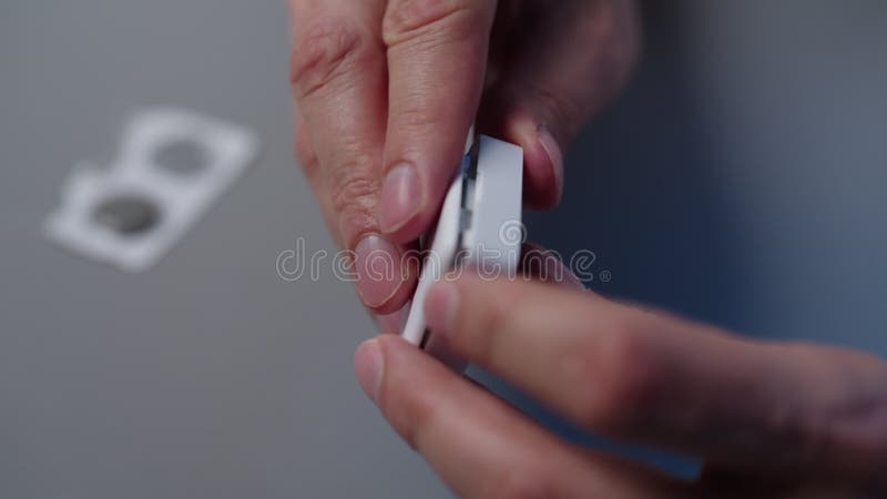 Person Replacing Button Cell Battery in Small White Square Digital ...