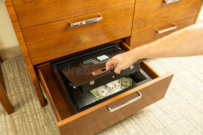 Person Retrieving Valuables from Safe in Hotel Room Stock Image - Image ...
