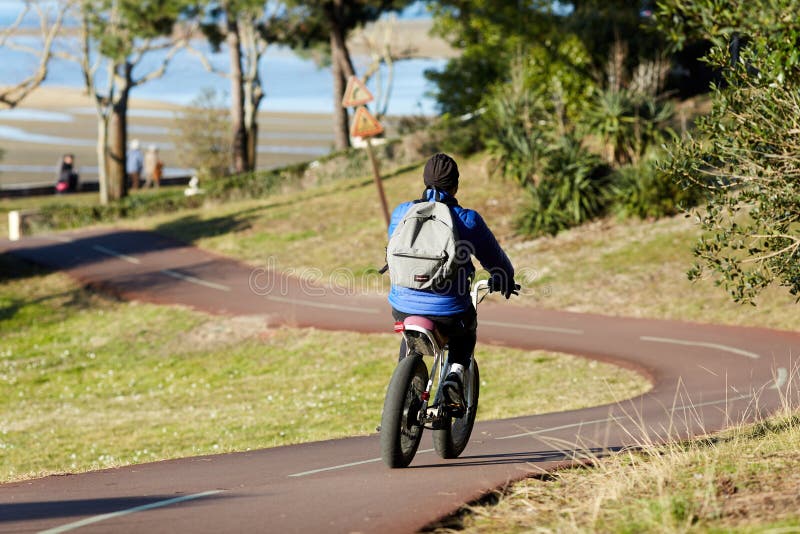 Person Riding a Bicycle on a Cycle Path Editorial Stock Image - Image ...
